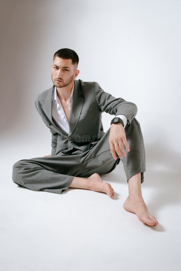 Handsome Man in Grey Suit Sits on the Floor Barefoot. Shoot in Studio ...