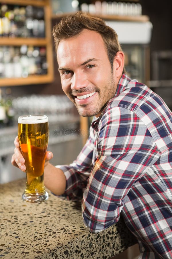 Handsome man having a beer stock photo. Image of happy - 67562542