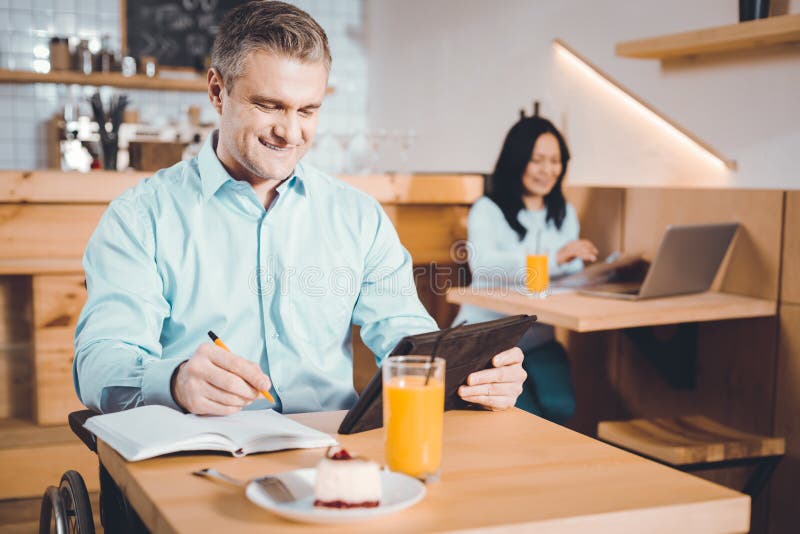 Handsome Man Having a Break in a Cafe Stock Photo - Image of paralysis ...