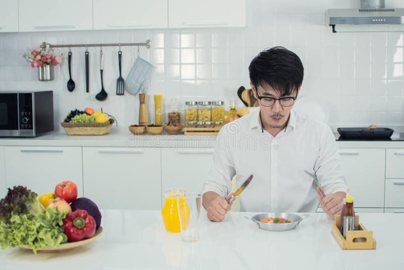 A Handsome Man is Having Breakfast in the Modern Kitchen Stock Image ...