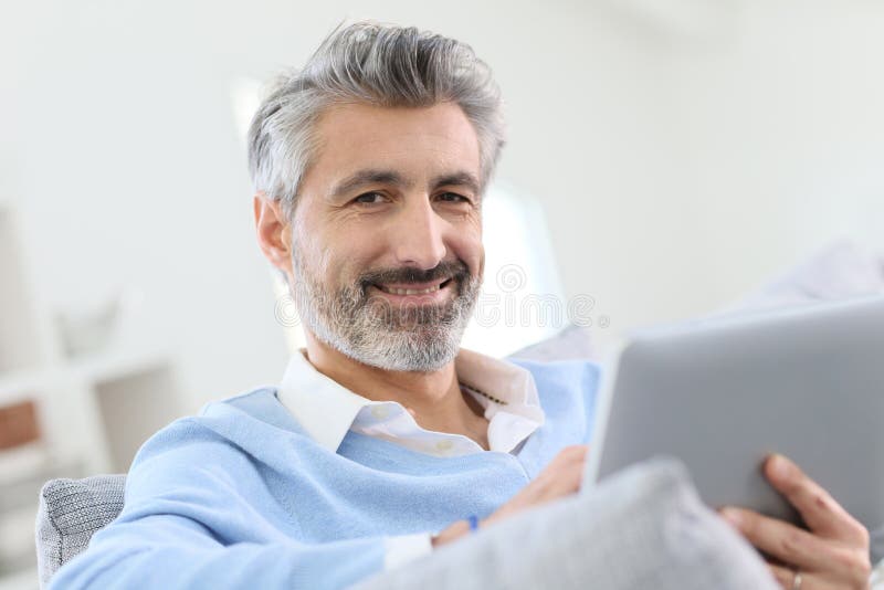 Handsome Man on His Tablet at Home Stock Photo - Image of hair ...