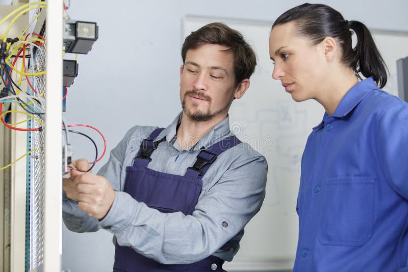 Handsome Man Holding Digital Multimeter Next To Woman Stock Photo ...