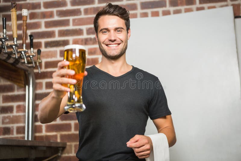 Handsome Man Holding a Pint of Beer Stock Photo - Image of serving ...