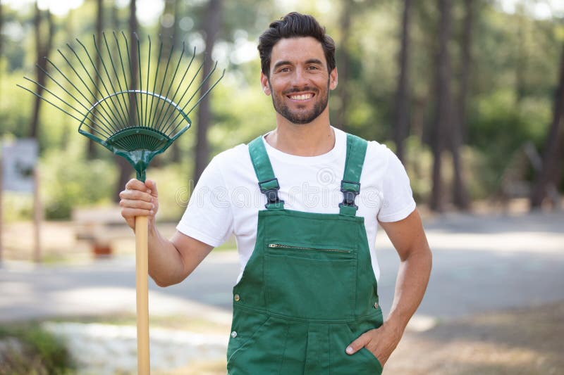 Handsome Man Holding Rake in Garden Stock Image - Image of casual ...