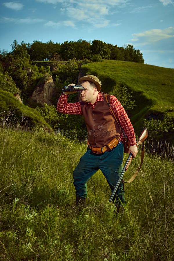 Handsome Man, Hunter in Hat with Feather Holding Weapon and Binoculars ...