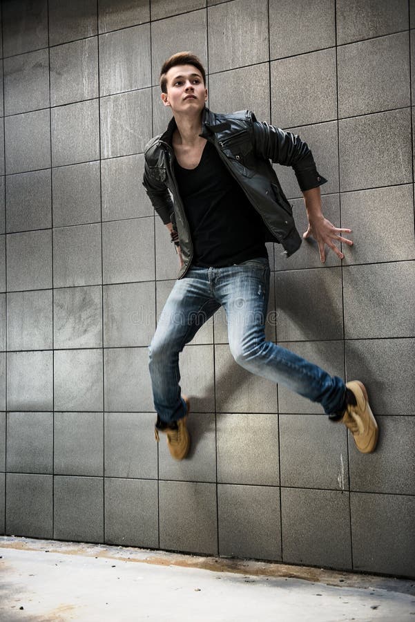 Handsome Man Jumping on the Street Wall Stock Image - Image of jump ...