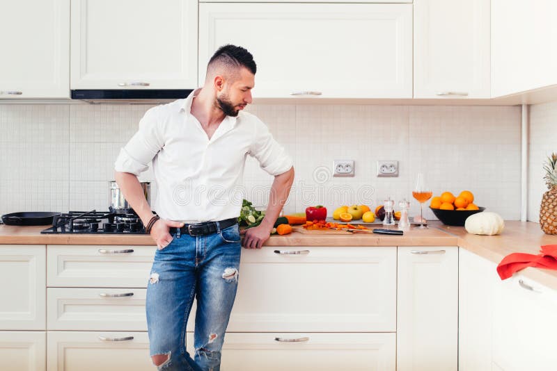 Handsome Man in Kitchen Preparing Food, Cooking and Posing Stock Image ...