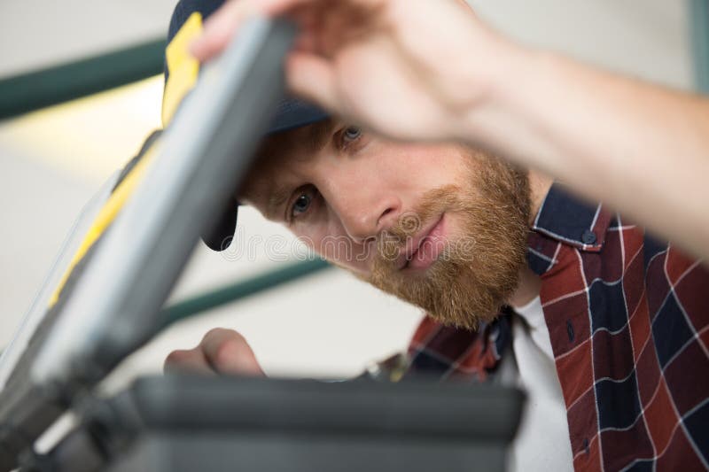 Handsome Man Looking Inside Tool Box while Standing in Kitchen Stock ...