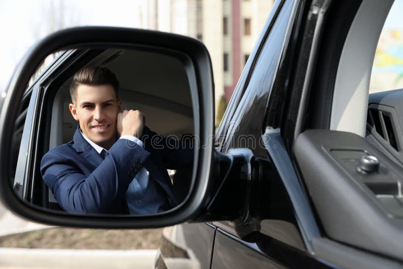 Handsome Man Looking into Side View Mirror of Car Outdoors Stock Photo ...