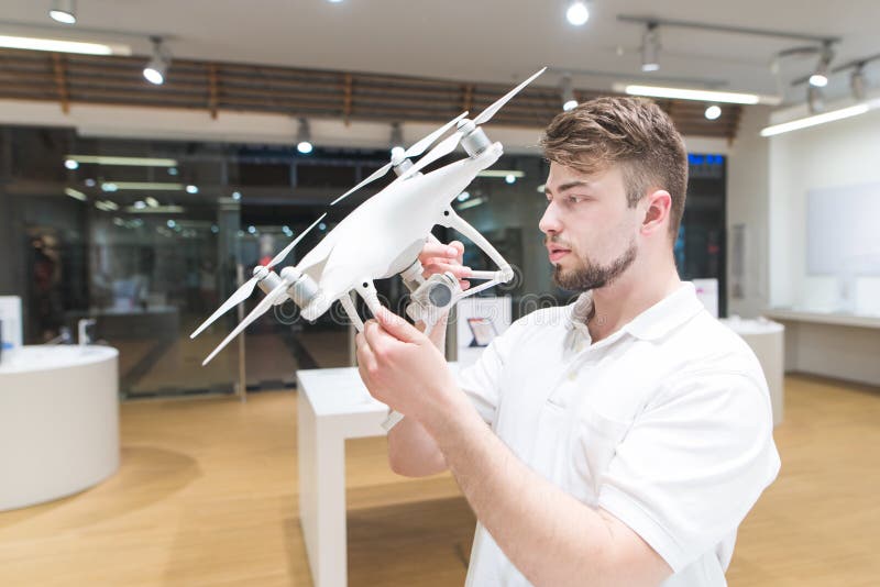 Handsome Man Looks at the Drone at the Modern Electronics Store Stock ...
