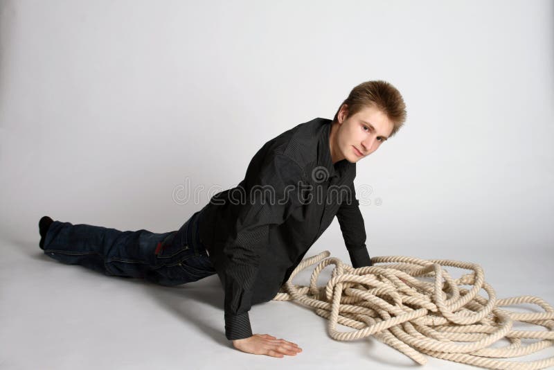 Handsome man lying on rope stock photo. Image of rising - 13141590