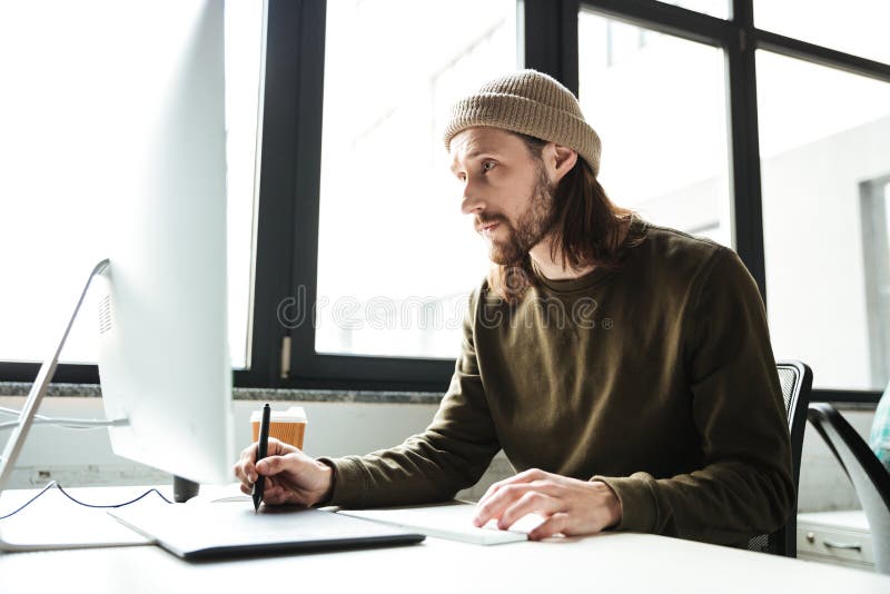 Handsome Man in Office Using Computer. Looking Aside Stock Image ...