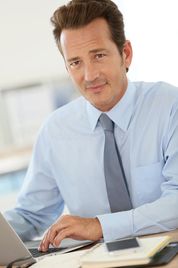 Handsome Man at Office Working on Laptop Stock Photo - Image of ...