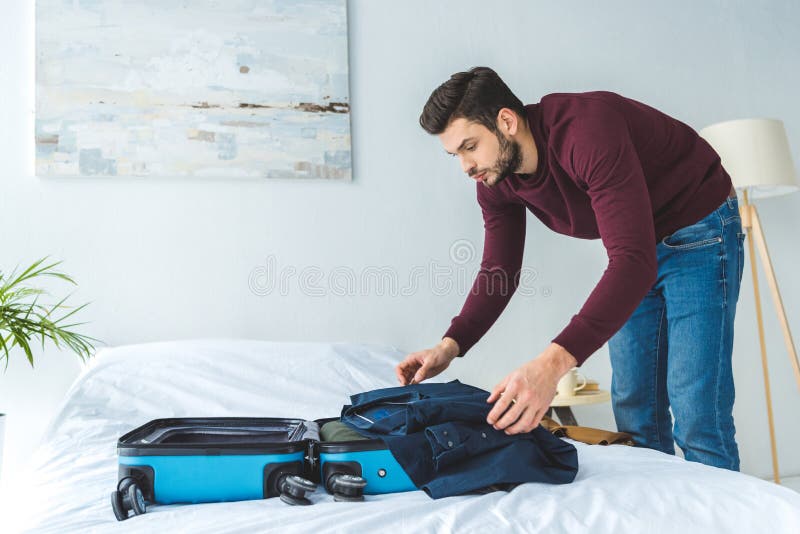 Handsome Man Packing Clothes into Travel Bag Stock Image - Image of ...