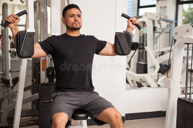 Handsome Man on a Pec Deck Machine Stock Photo - Image of training ...