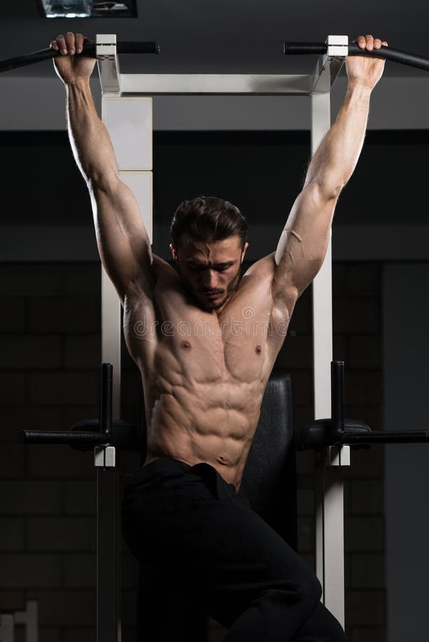 Handsome Man Performing Hanging Leg Raises Exercise Stock Photo - Image ...