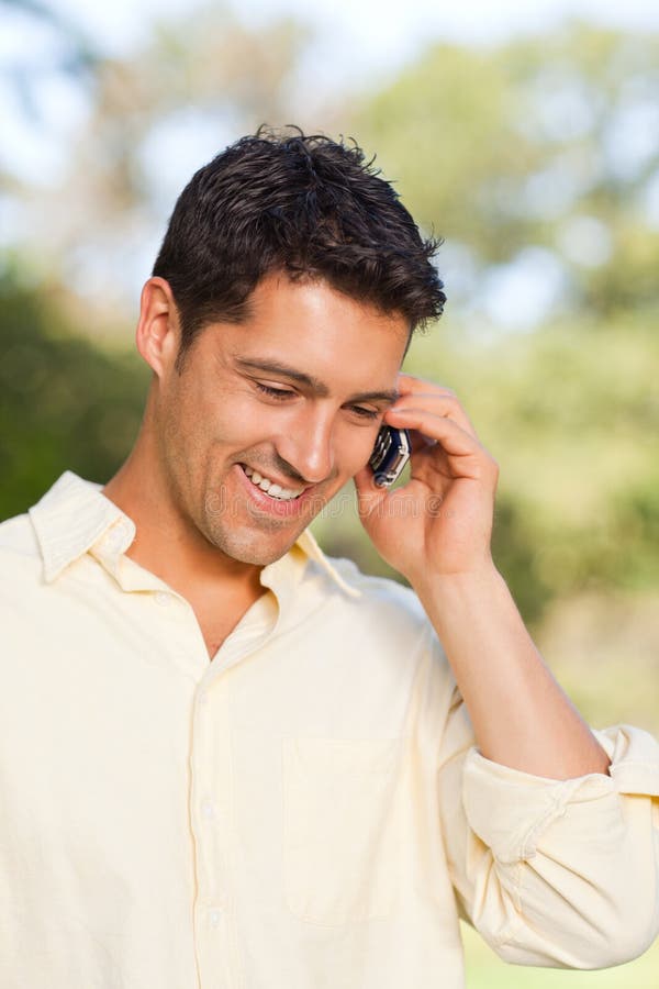 Handsome Man Phoning in the Park Stock Image - Image of male, cell ...