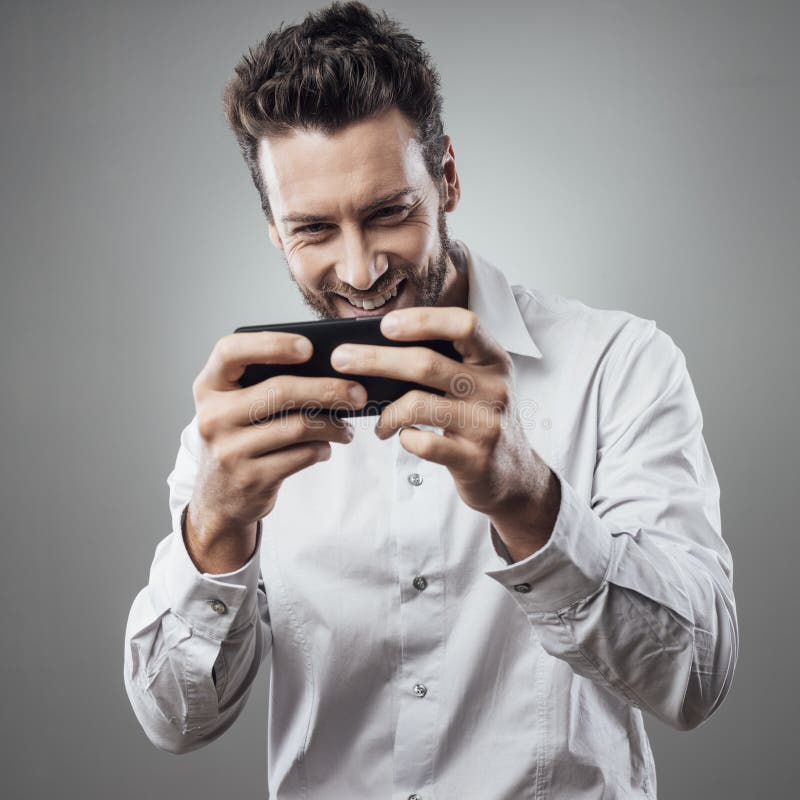 Handsome Man Playing with His Smartphone Stock Photo - Image of ...