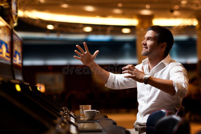 Handsome Man Playing the Slot Machine Stock Photo - Image of male, game ...