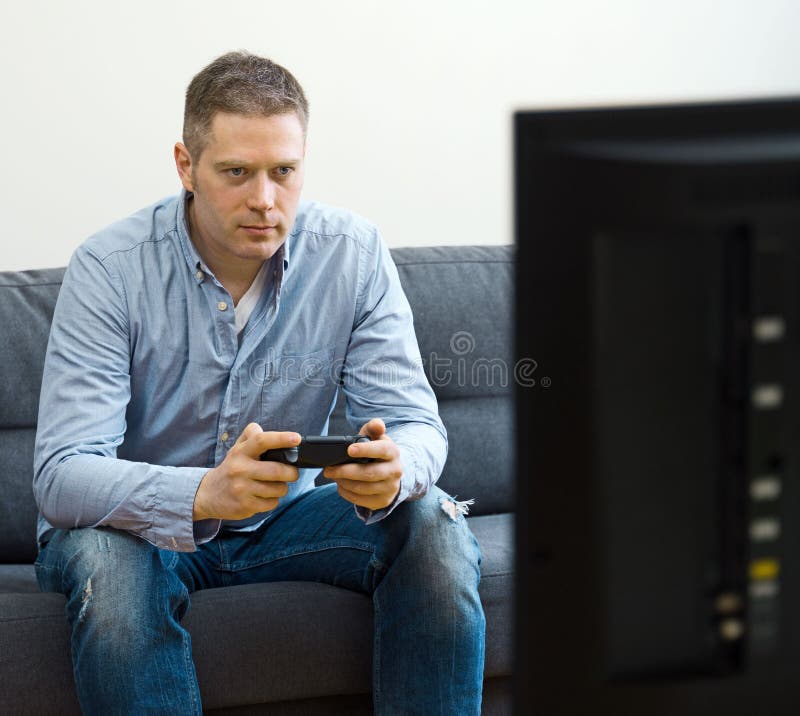 Man playing video game. stock image. Image of hobby - 147010271