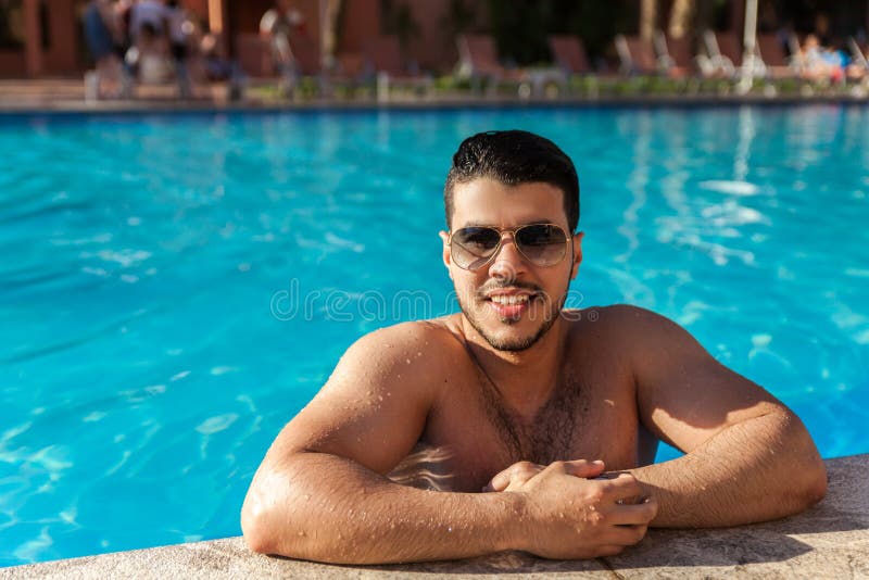 Handsome man in pool stock image. Image of luxury, blue - 92881887