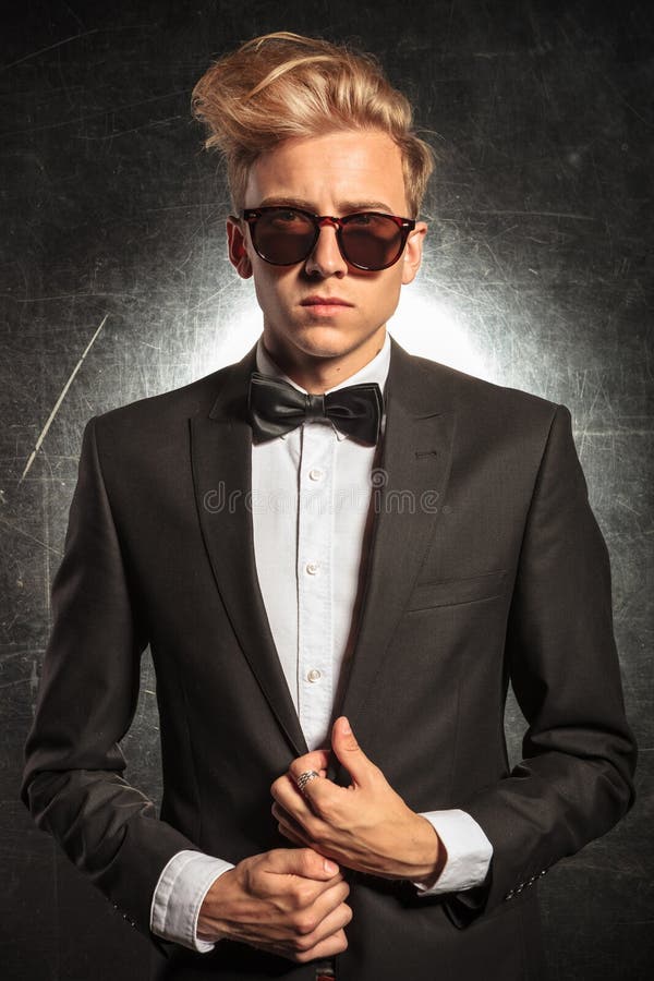 Handsome Man Posing in Studio while Fixing His Jacket Stock Photo ...