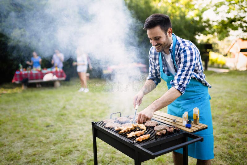 Handsome Man Preparing Barbecue Stock Photo - Image of barbecue, people ...