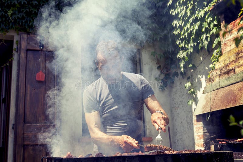 Handsome Man Preparing Grilled Meat Stock Photo - Image of meal, grid ...