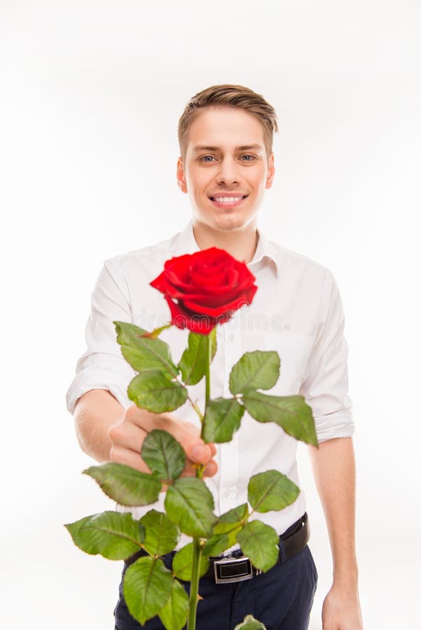 Handsome Man Presenting Red Rose at Camera Stock Photo - Image of ...