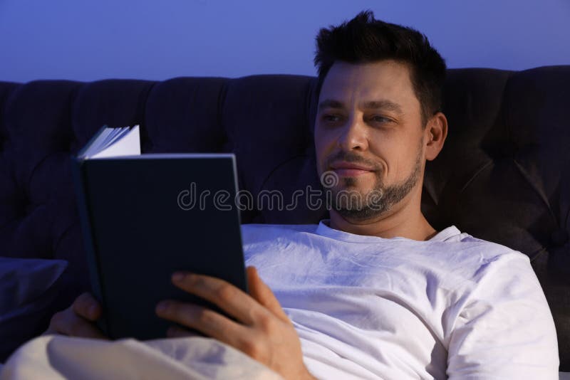 Handsome Man Reading Book in Dark Room at Night Stock Photo - Image of ...