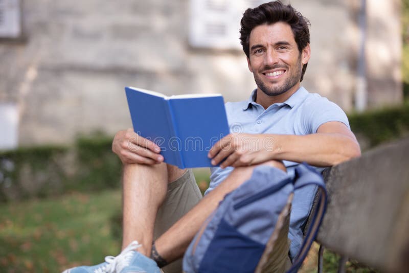 Handsome Man Reading Book Outdoors Stock Image - Image of ...