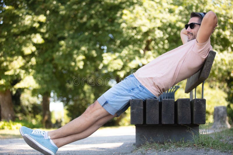 Handsome Man Relaxing on Bench Stock Photo - Image of tablet, forties ...