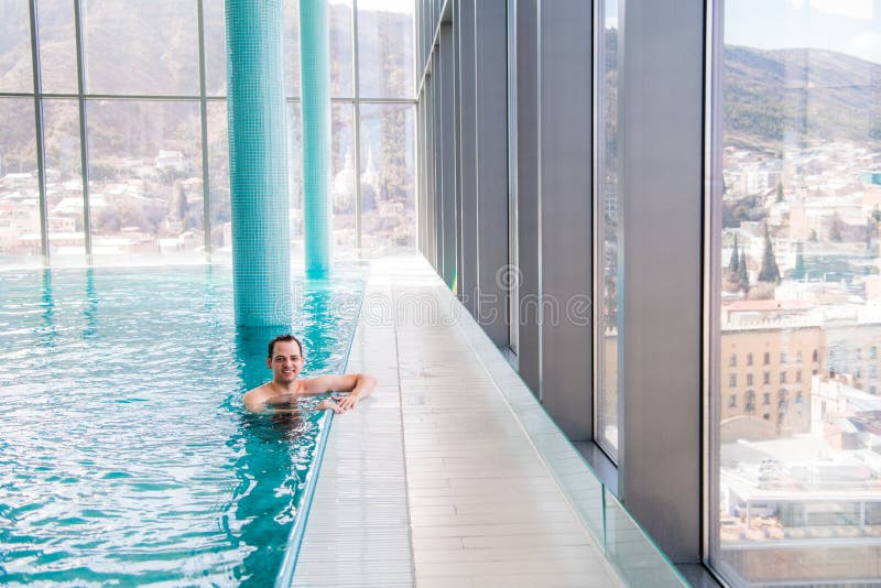 Handsome Man Relaxing in a Indoor Swimming Pool Stock Image - Image of ...