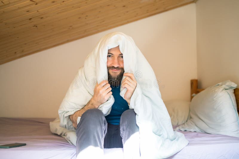 Handsome Man Relaxing Under Soft Blanket in Bed at Home Stock Photo ...