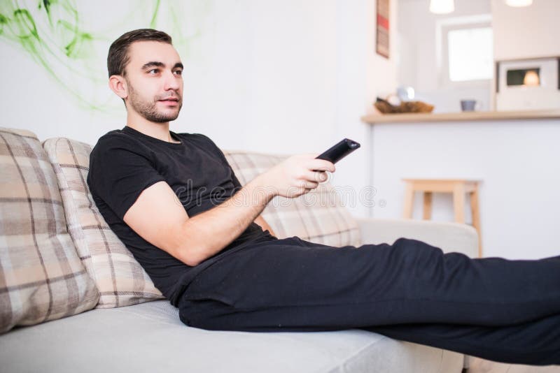Handsome Man with Remote Control on Sofa at Home Stock Image - Image of ...