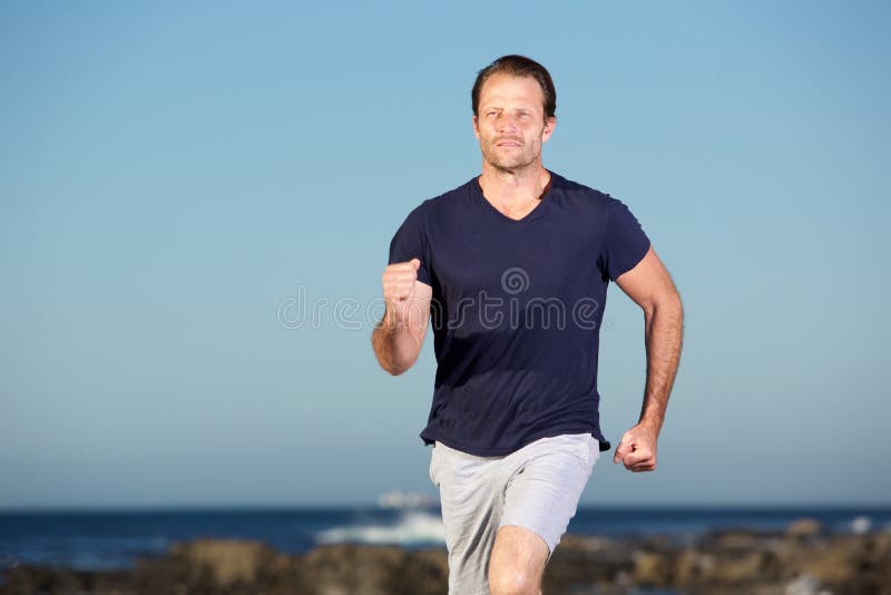Handsome Man Running Outdoors by the Beach Stock Photo - Image of ...
