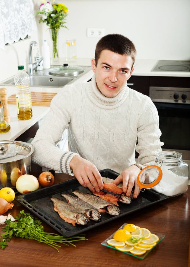 Handsome Man Salting Fish on Baking Sheet Stock Image - Image of ...