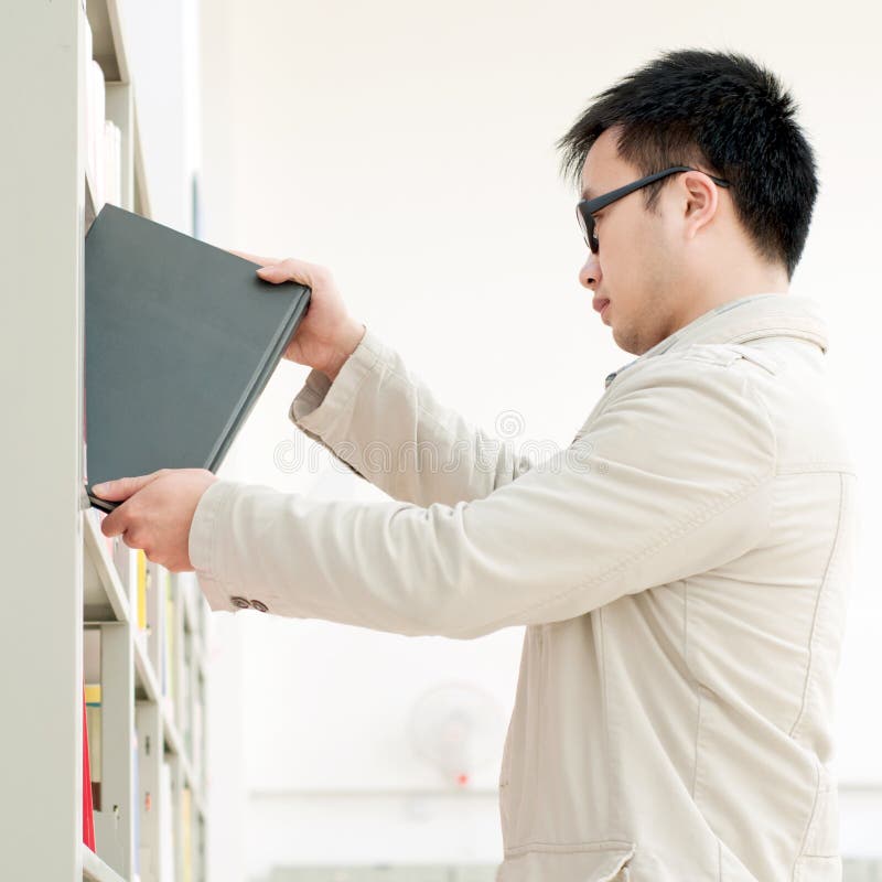 Handsome Man, the Selection of Books in the Librar Stock Image - Image ...