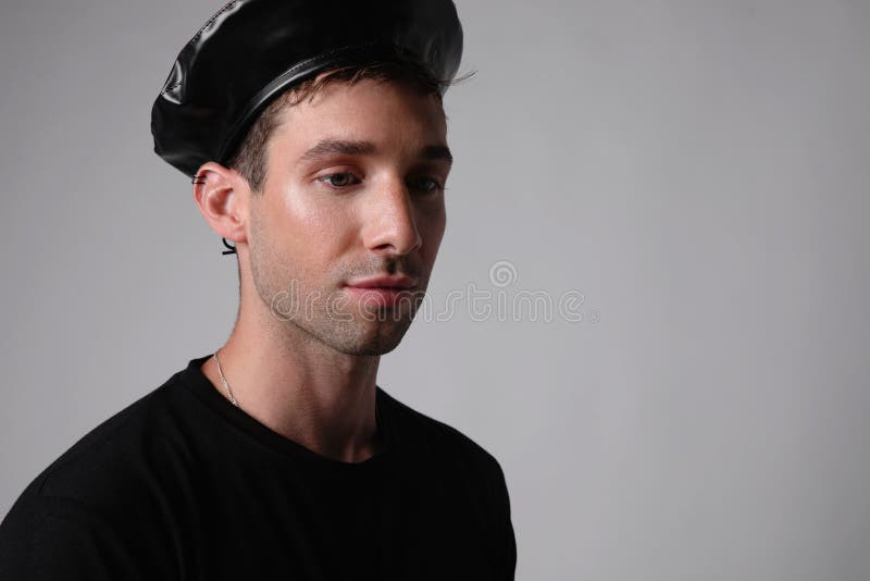 Handsome Man with Serious Face Expression Wears Black Hat Over White ...