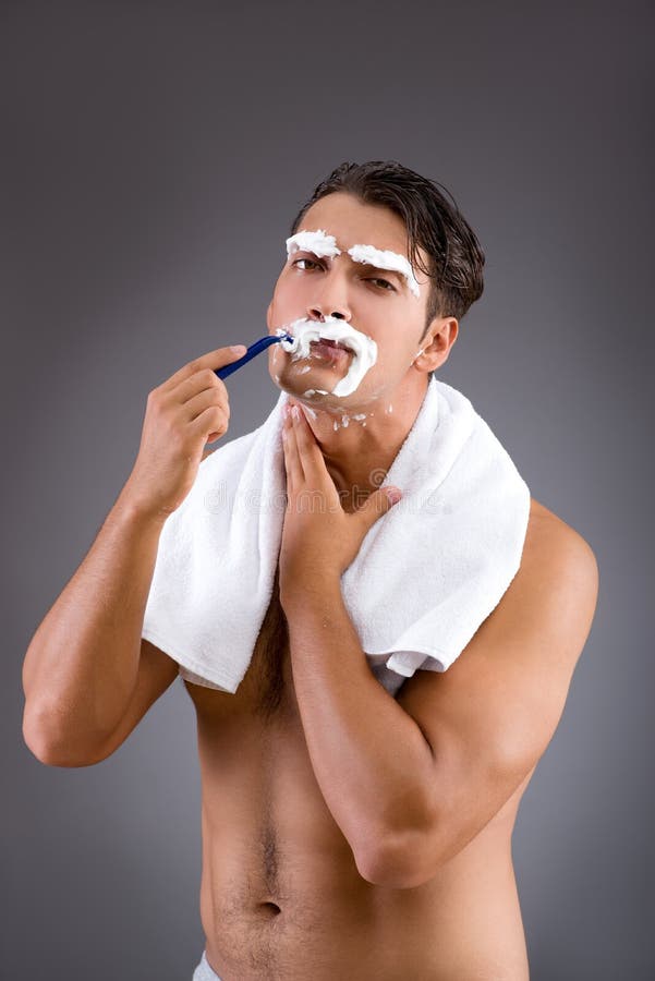 The Handsome Man Shaving Against Dark Background Stock Photo - Image of ...