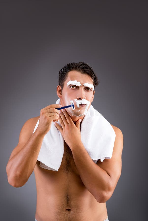 The Handsome Man Shaving Against Dark Background Stock Image - Image of ...