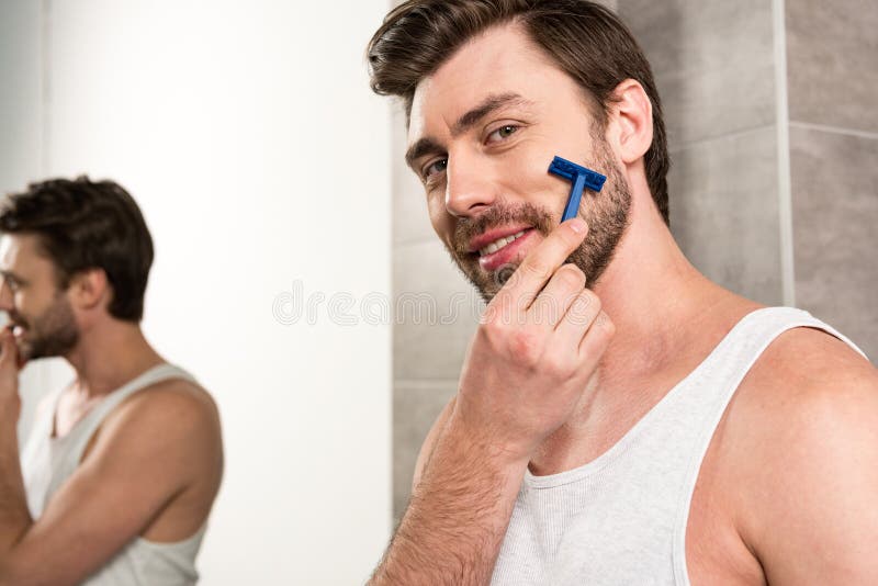Man Shaving Beard with Razor in Bathroom Stock Photo - Image of ...