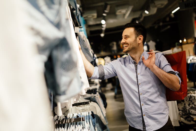 Handsome Man Shopping for Clothes Stock Image - Image of mall, apparel ...