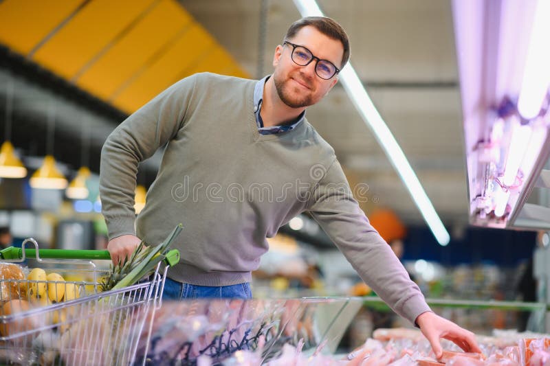 Handsome Man Shopping in a Supermarket Stock Image - Image of choosing ...