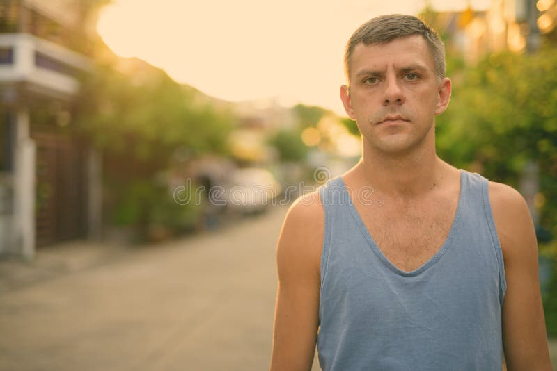 Handsome Man with Short Hair Relaxing in the Streets Outdoors Stock ...