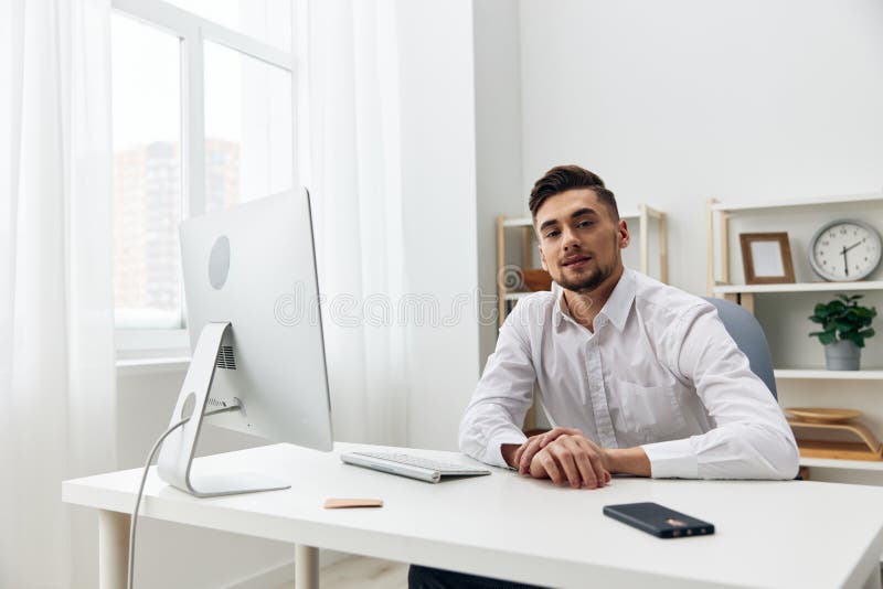 Handsome Man Sitting at a Desk in Front of a Computer with a Keyboard ...