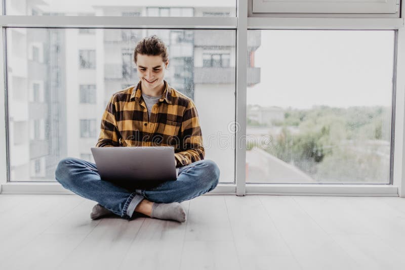 Handsome Young Man Sitting on Floor Using Laptop at Home Stock Image ...