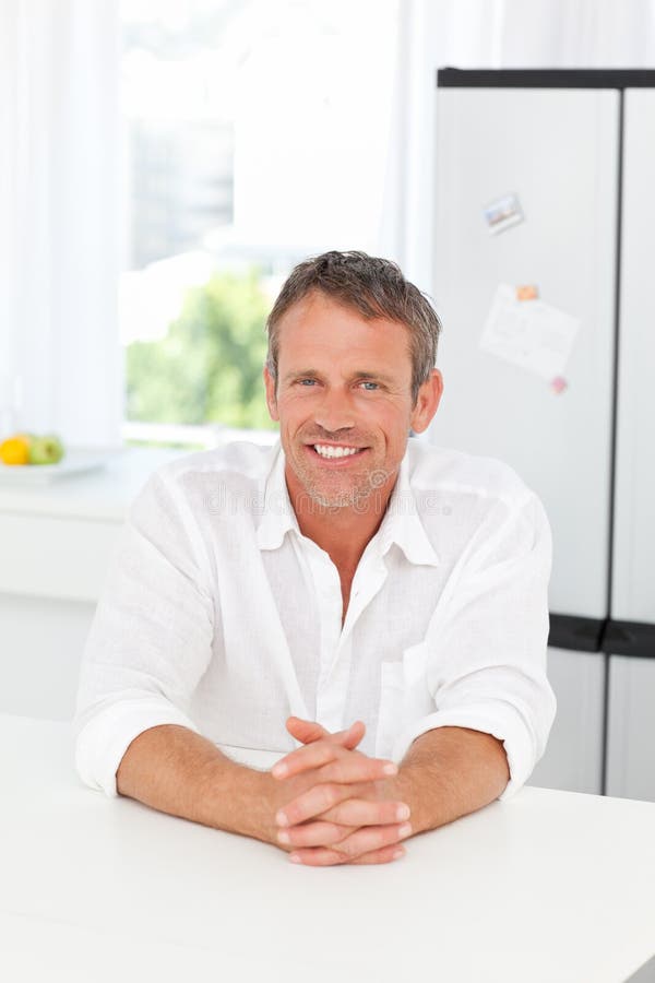 Handsome Man Sitting in His Kitchen Stock Photo - Image of table, smile ...