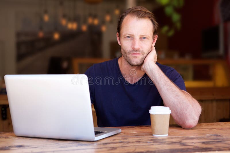 Handsome Man Sitting with Laptop Stock Photo - Image of cool, looking ...