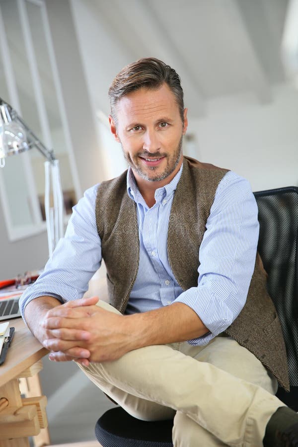 Handsome Man Sitting at Office and Smiling Stock Image - Image of ...